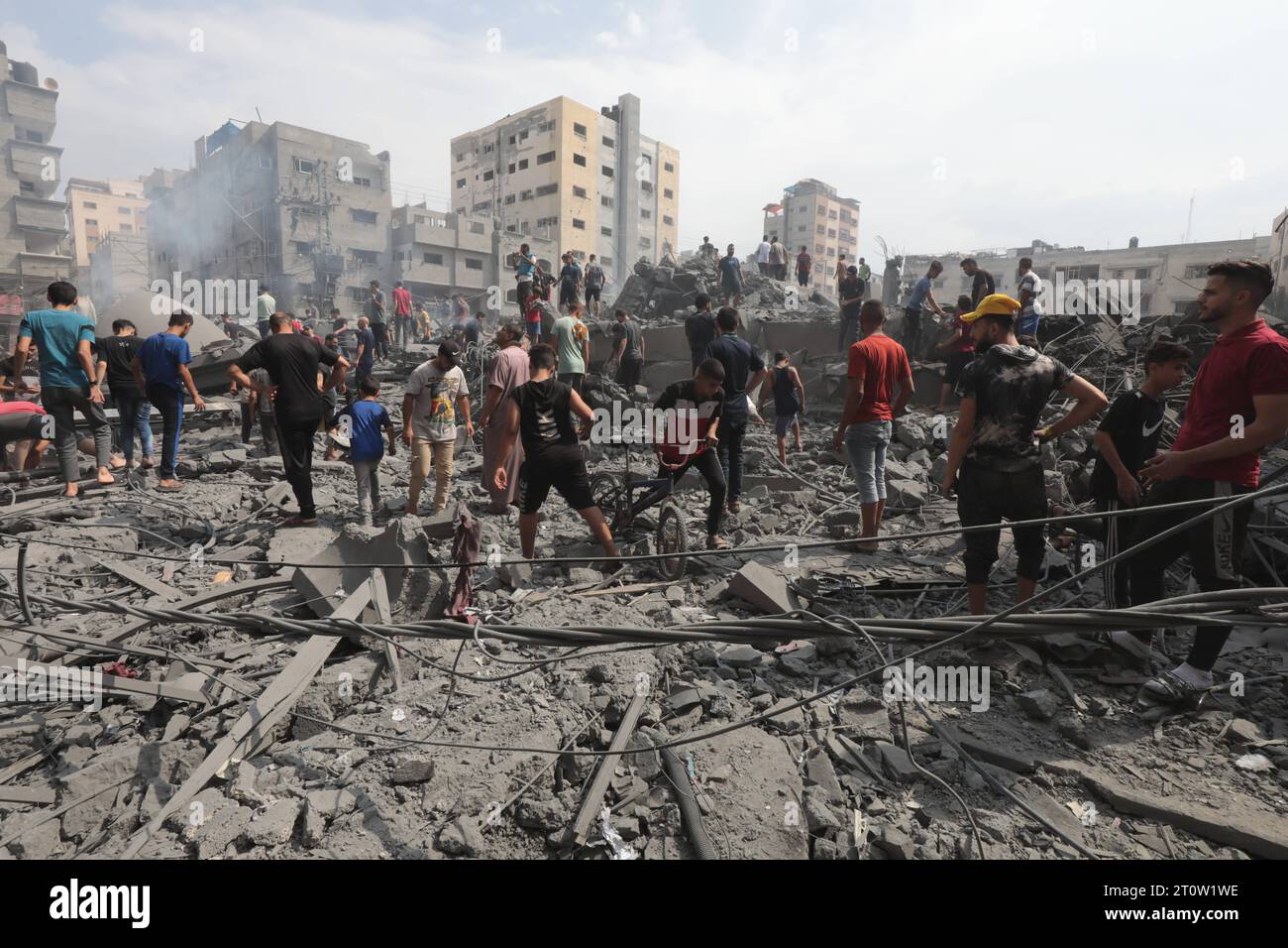 Palestinians inspect the damage following an Israeli airstrike on the ...