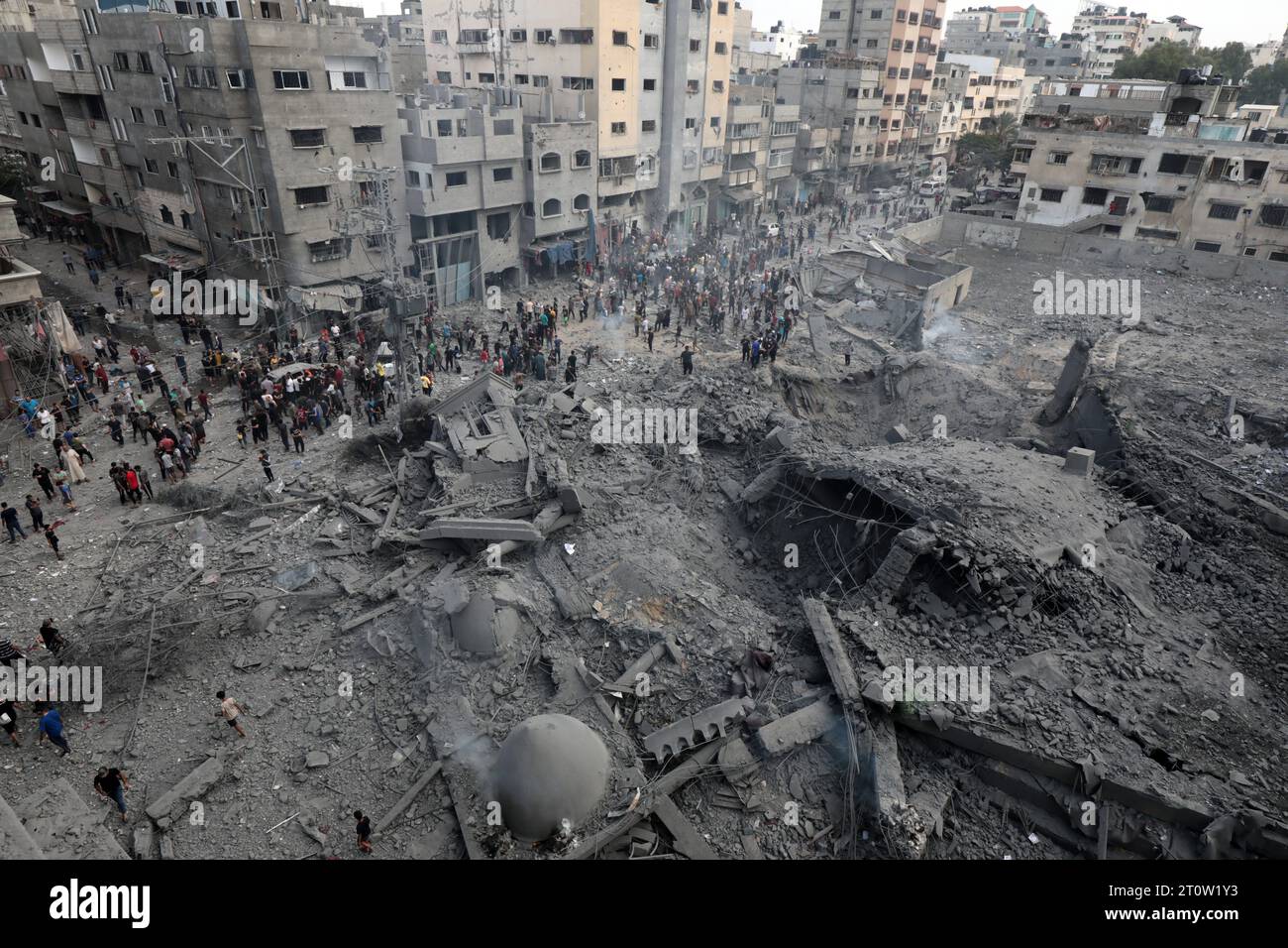 Palestinians inspect the damage following an Israeli airstrike on the ...