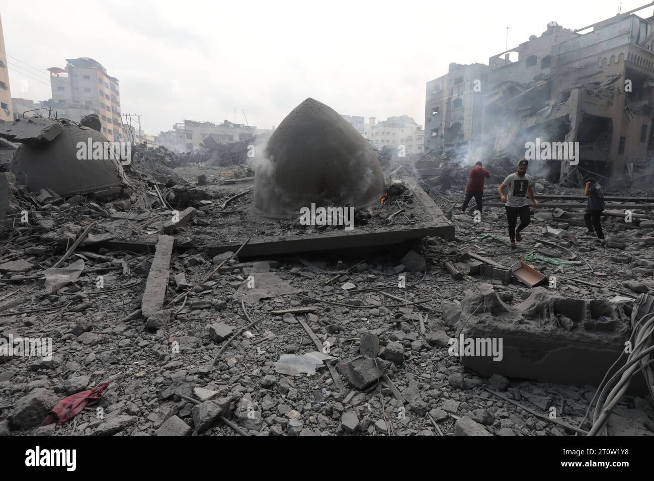 Palestinians inspect the damage following an Israeli airstrike on the ...