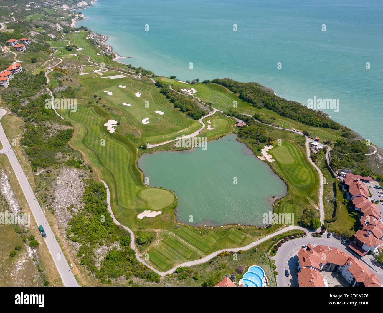 Aerial view of the golf course stretches out beneath, its lush green ...