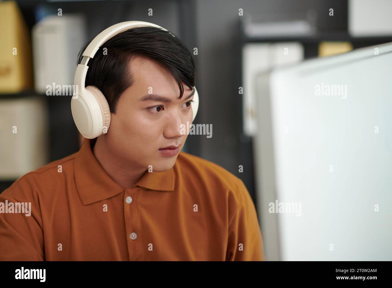 Portrait of developer reviewing programming code on computer screen ...