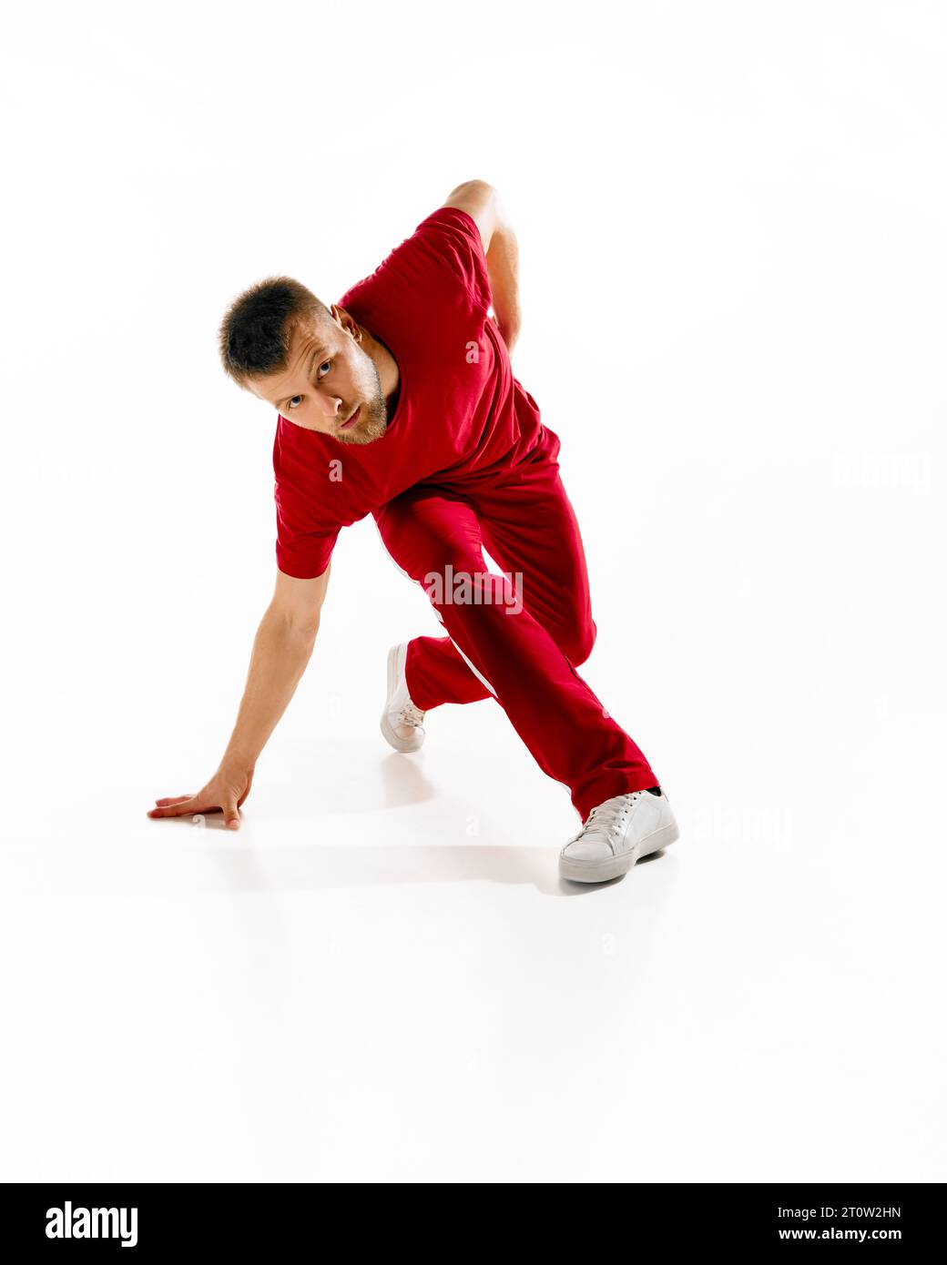 Portrait of young man, dancer performing hip-hop, breakdance, flexing elements in motion in ...