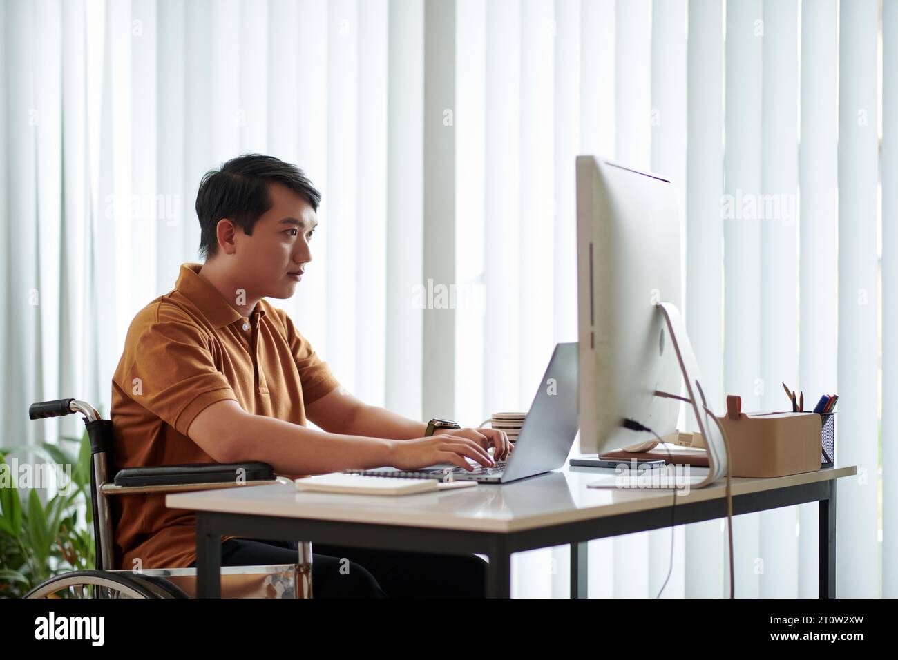 Young man with disability working as software developer at home Stock Photo - Alamy
