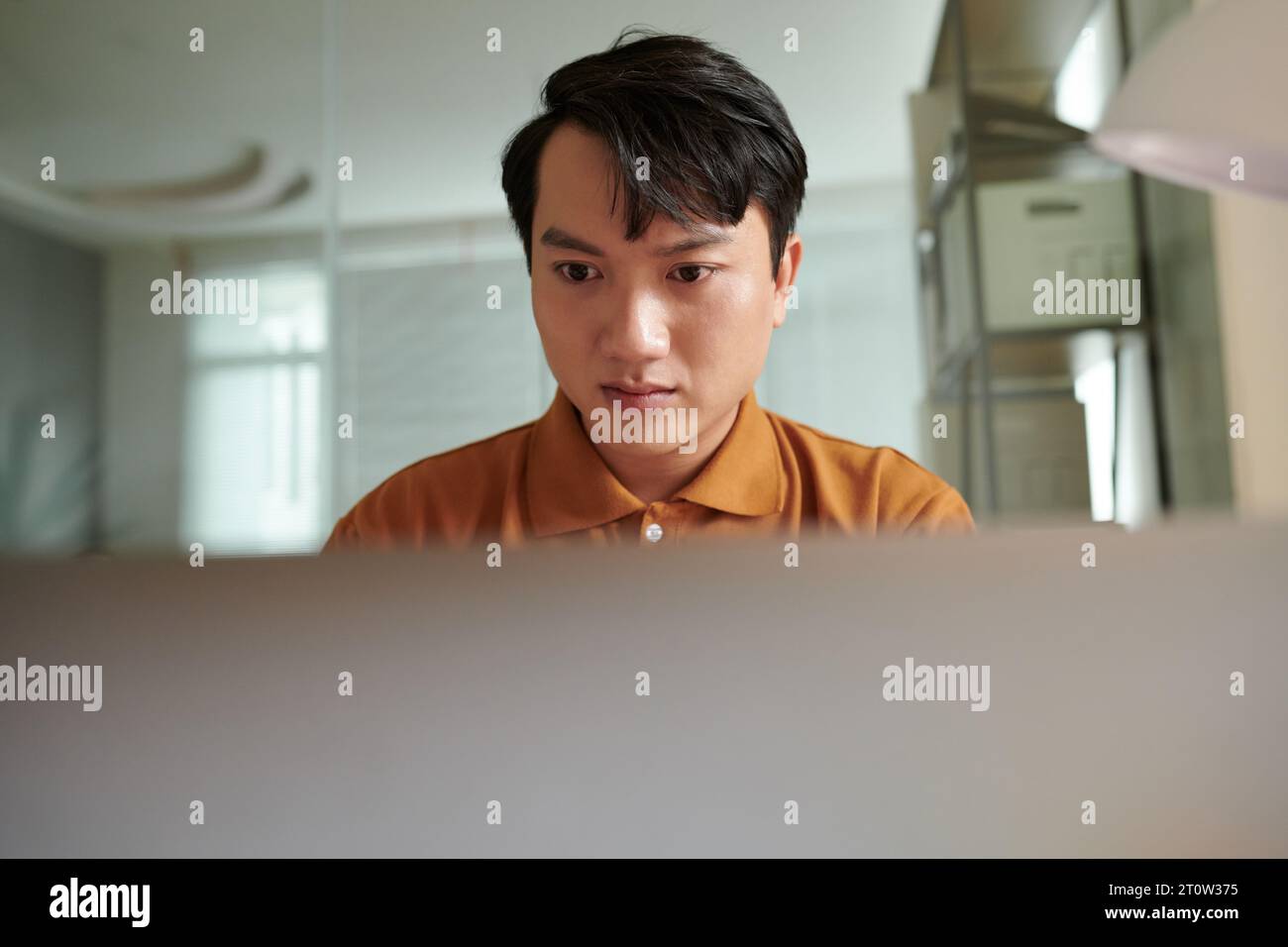 Pensive software developer searching for bugs in programming code Stock Photo - Alamy