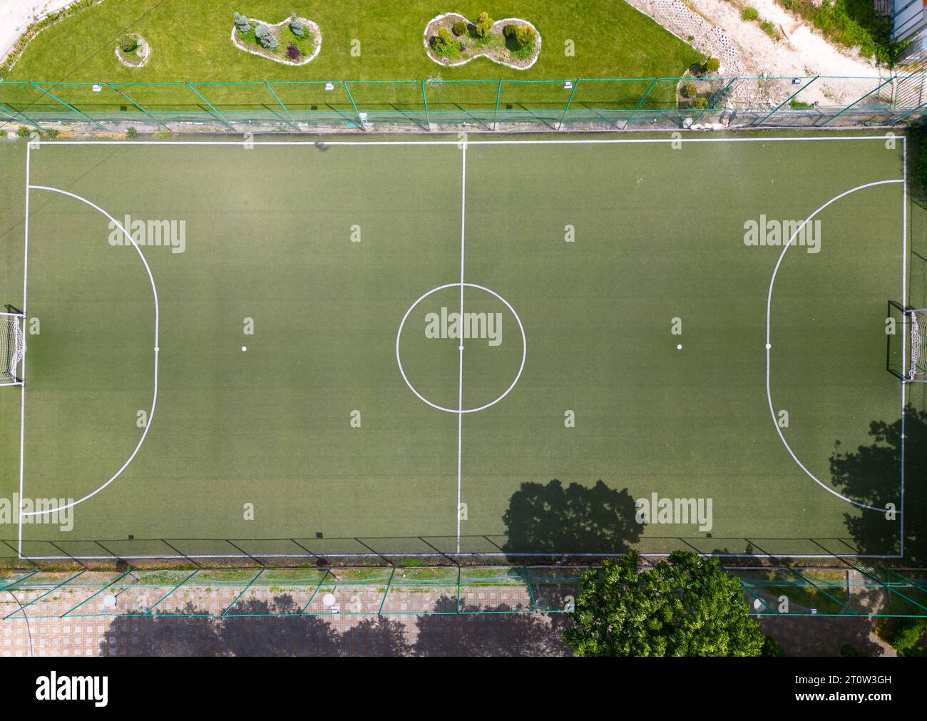 From an aerial perspective, an empty football field comes into view ...