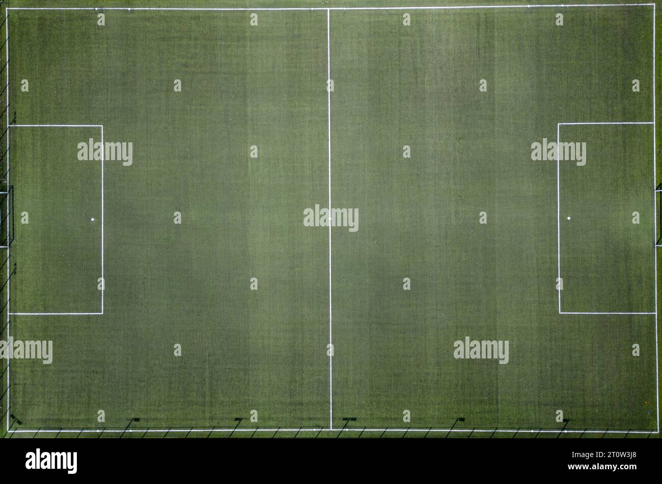 From an aerial perspective, an empty football field comes into view ...