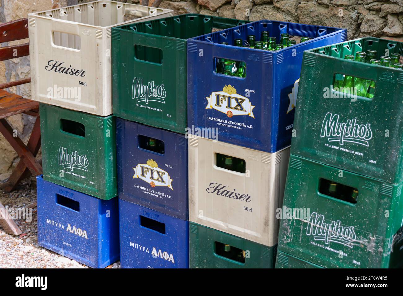 Greek beer brands crates with open and empty glass bottles. Mythos beer ...