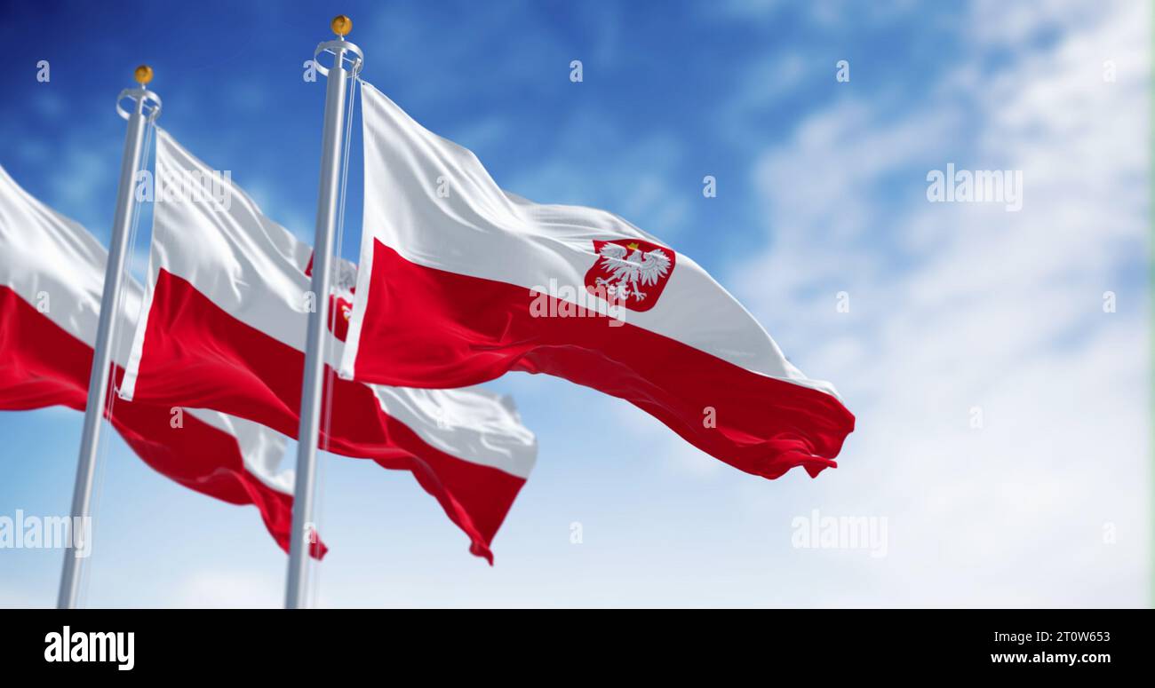 Three National flags of Poland waving in the wind on a clear day. Two ...