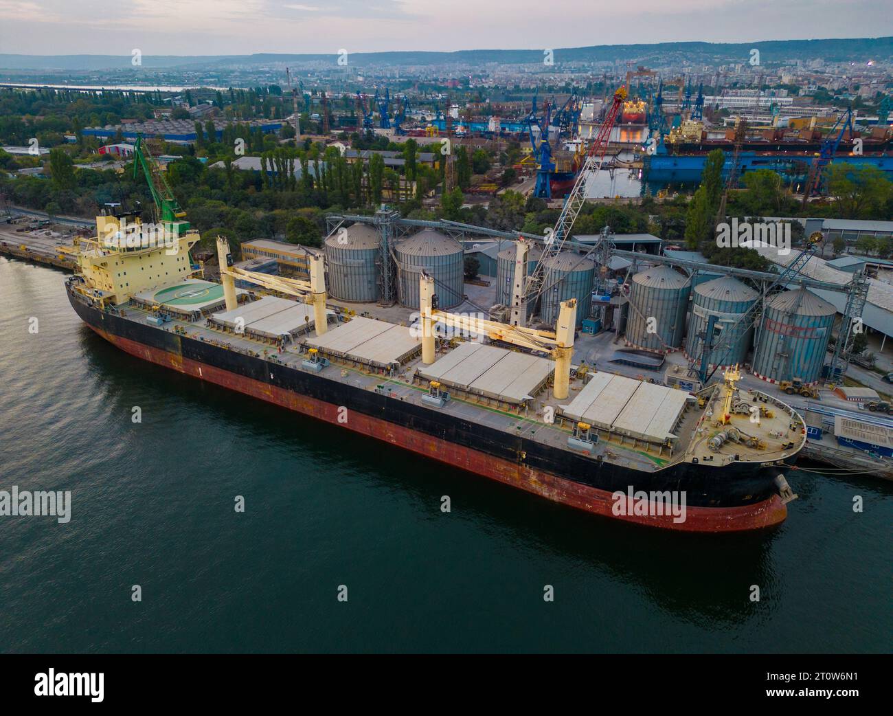 Aerial view of big cargo ship bulk carrier in the port at sunset ...
