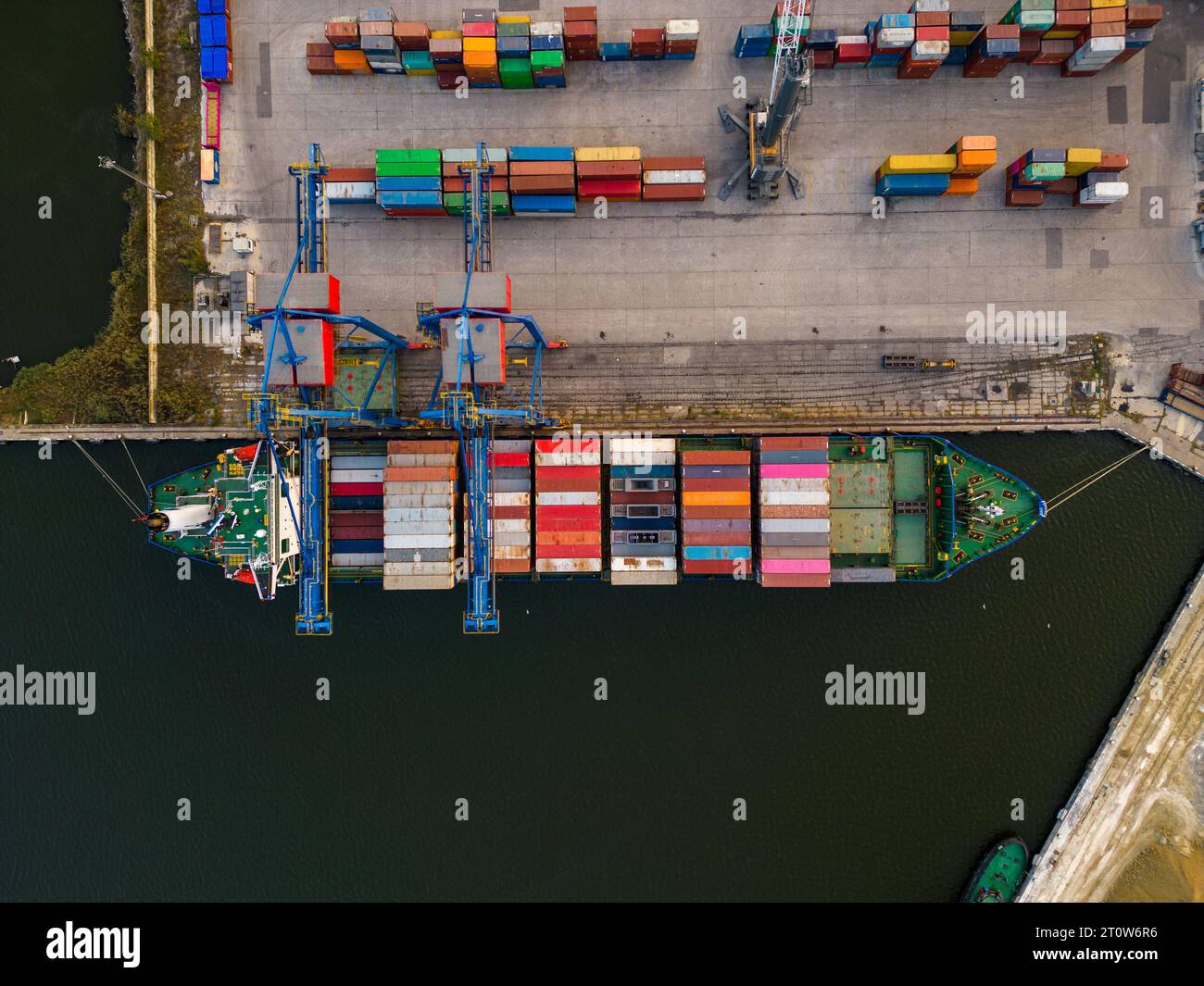 aerial view of a container ship in terminal at the port, where massive ...