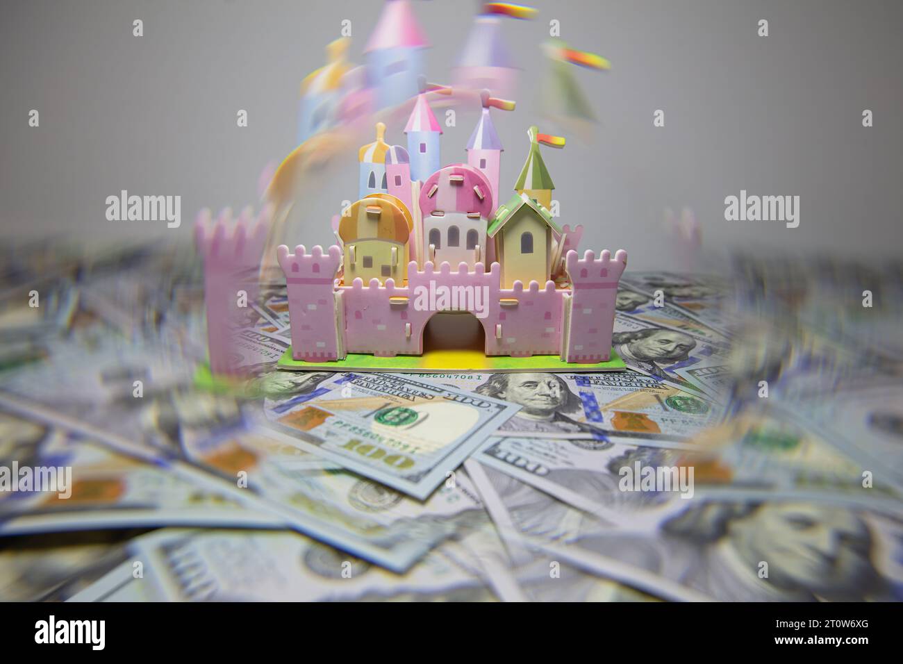 pink toy castle isolated on US 100 dollar banknotes for design purpose ...