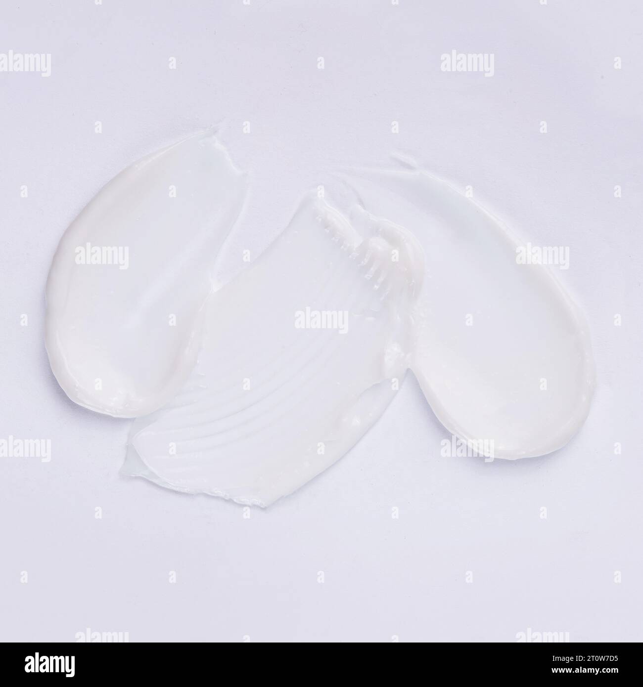 Set with face care cosmetics smears on white background, top view. Face ...