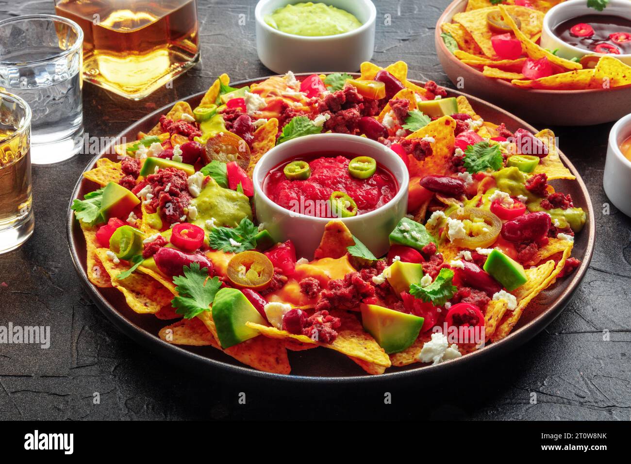 Loaded nachos. Mexican nacho chips with beef, with guacamole sauce ...