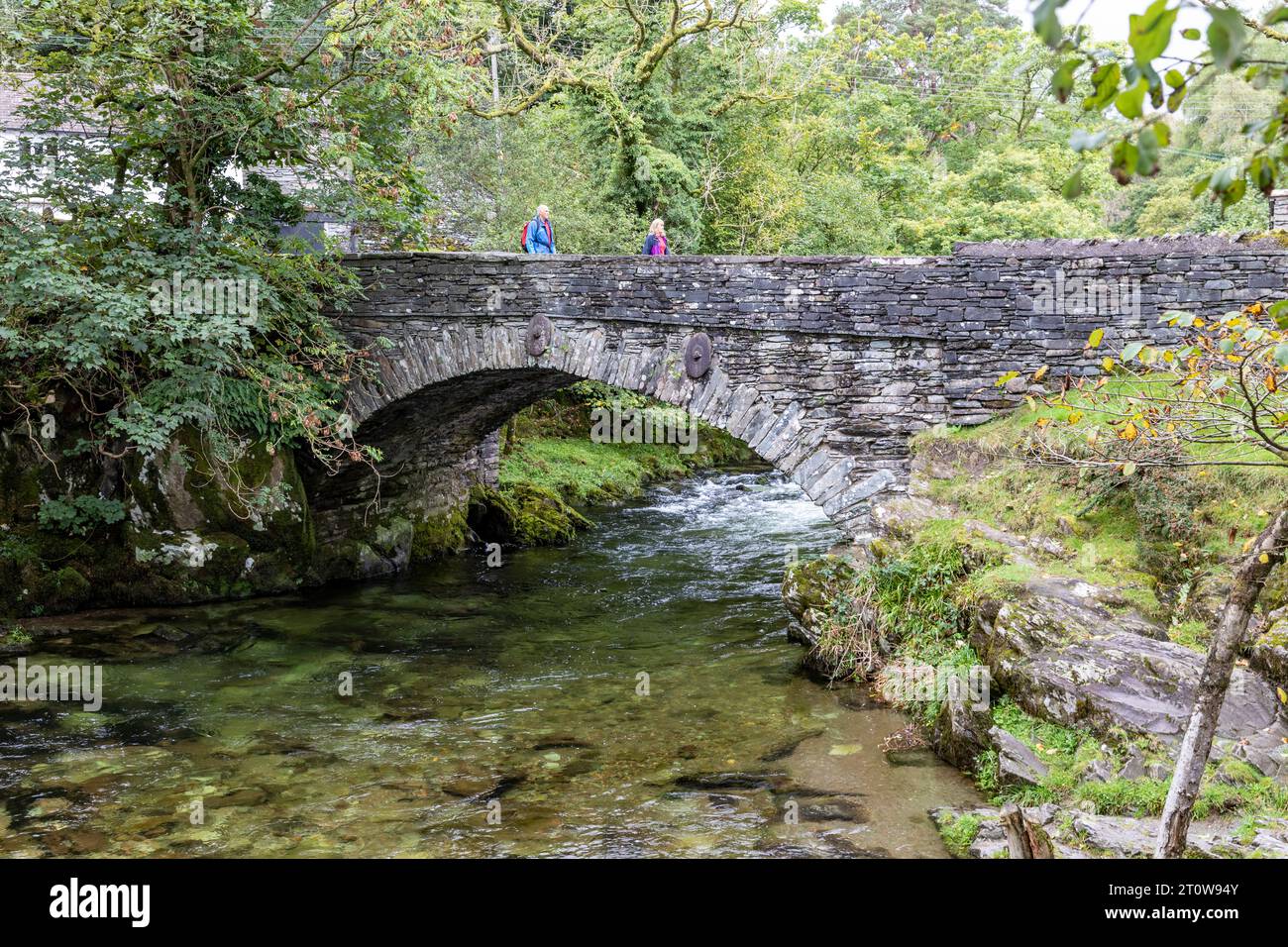 Elterwater village and bridge in the Lake District, River Brathay flows ...