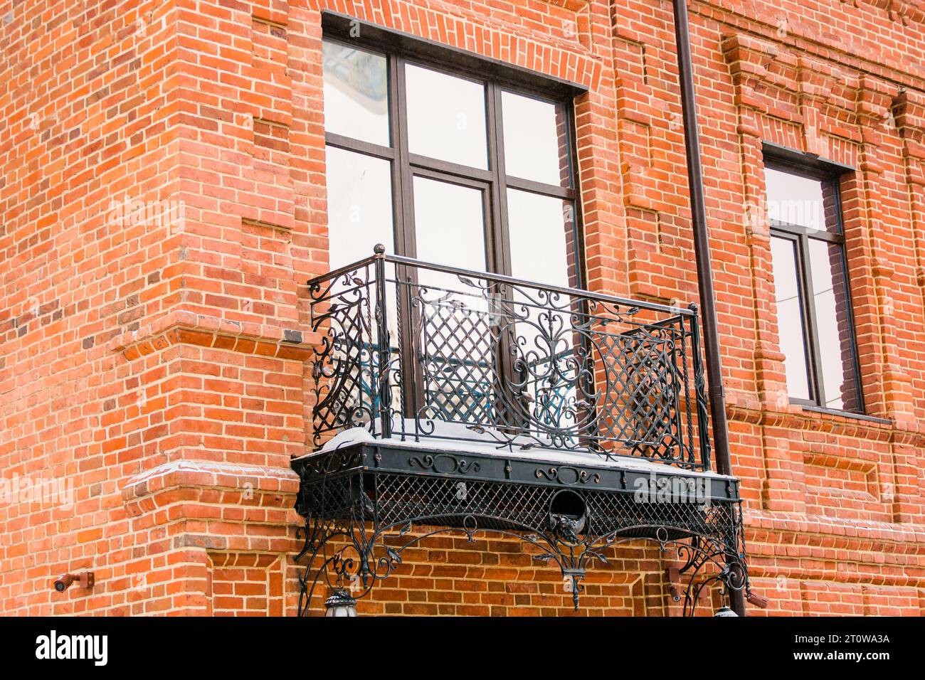 Facade of old house with beautiful balcony with snow in winter. Balcony ...