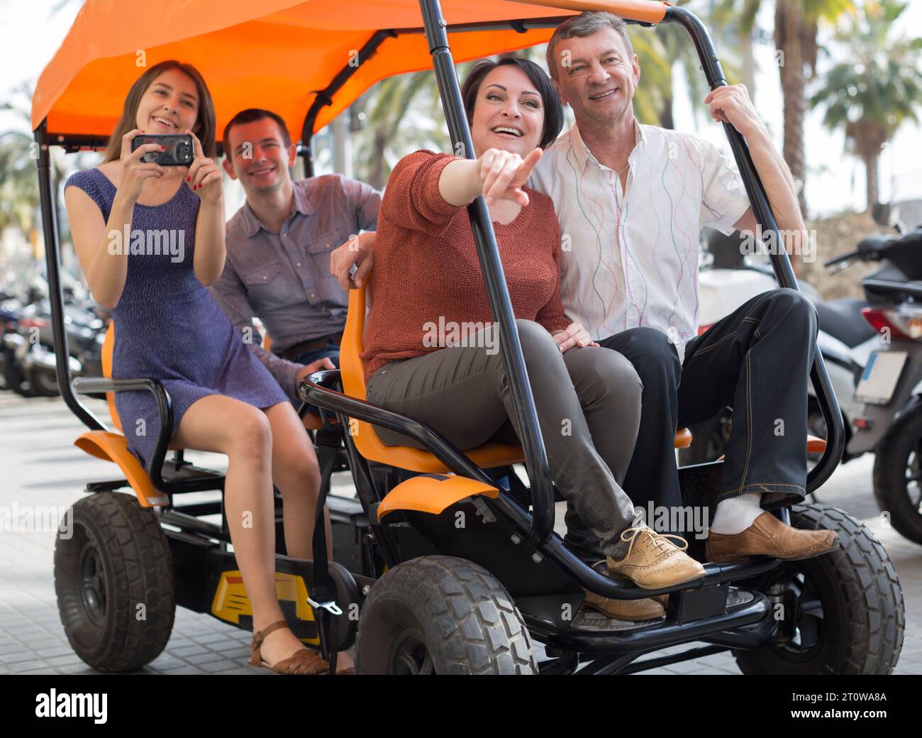 Family of tourists enjoy a walk on the bike carriage Stock Photo - Alamy