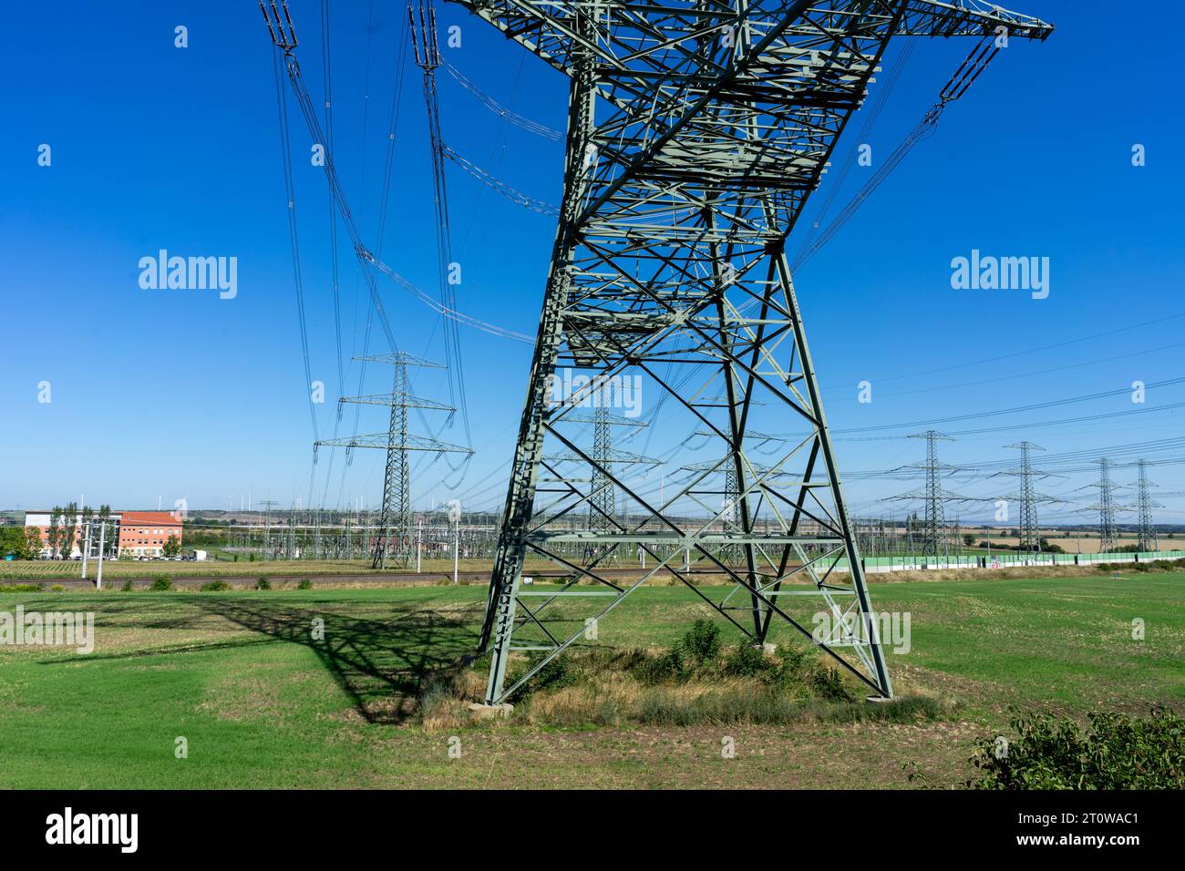 mega electric power lines in the field Stock Photo - Alamy