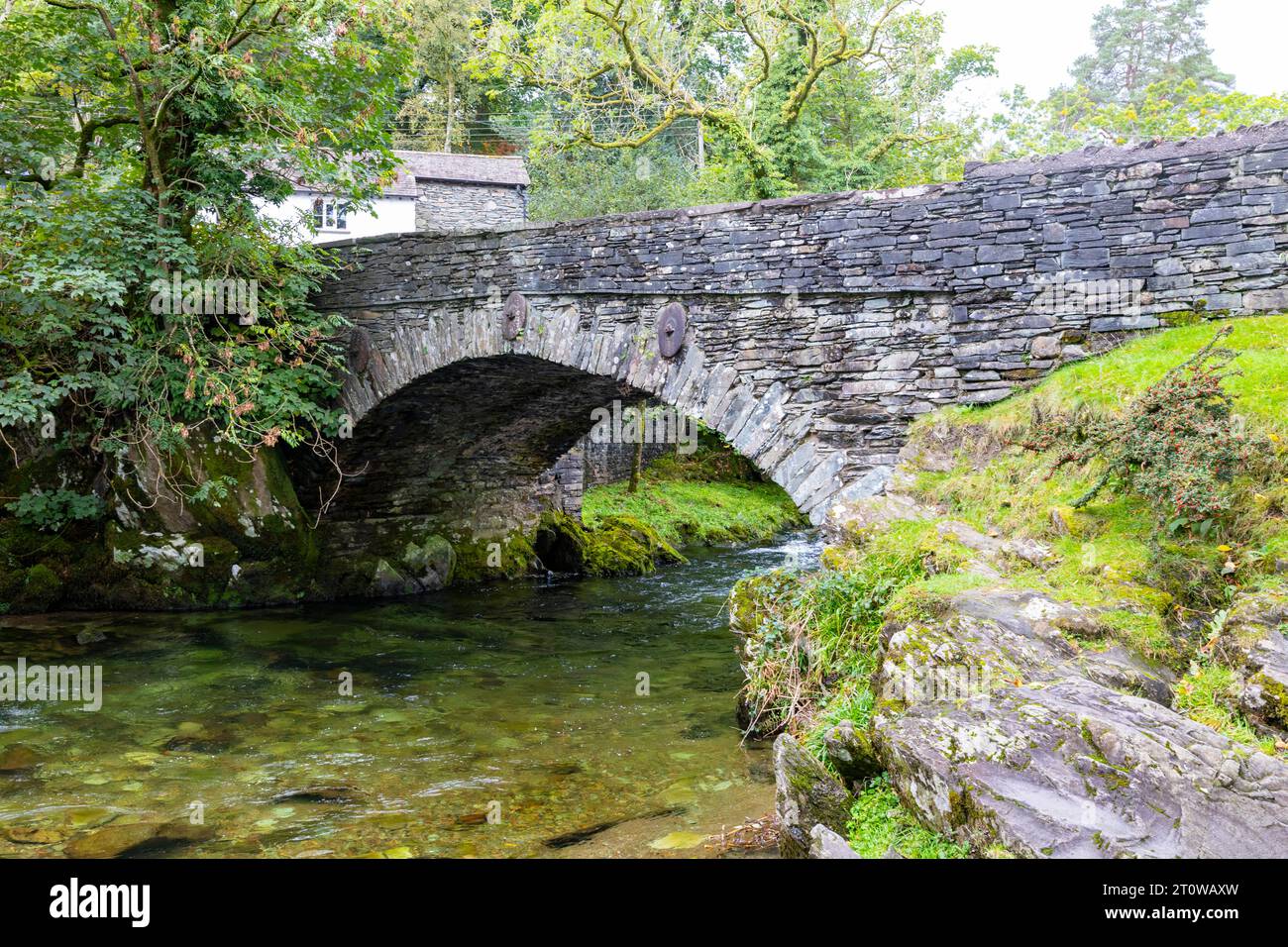 Elterwater village and bridge in the Lake District, River Brathay flows ...