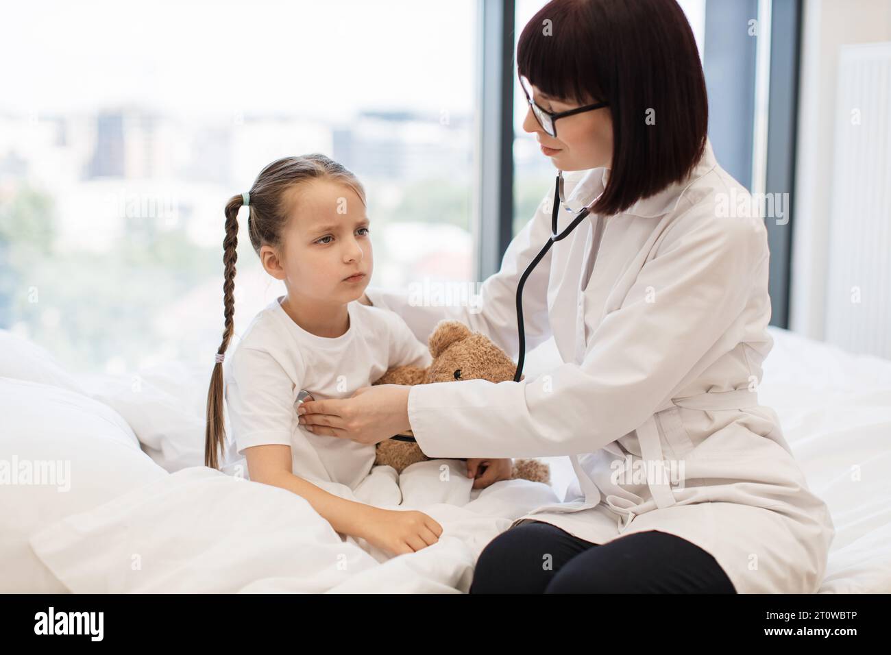 Kind nurse using stethoscope to check up preschool girl Stock Photo - Alamy