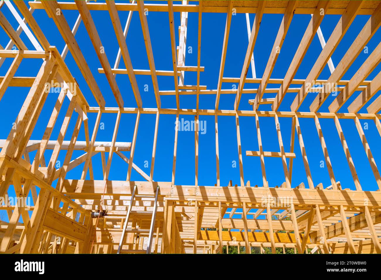 Wooden support beams in frame trusses roof construction for new house ...