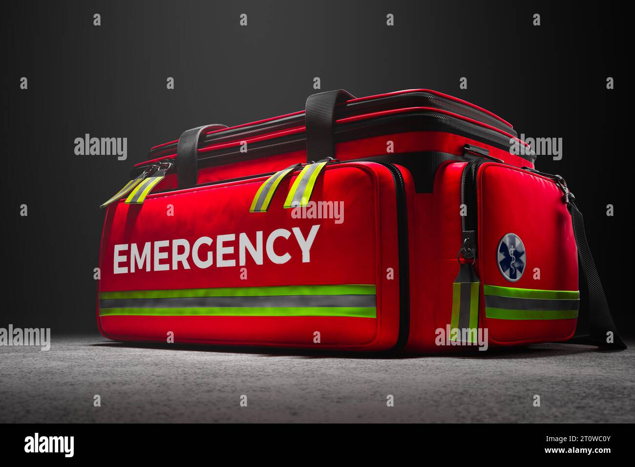 A professional red emergency first aid bag on in studio spotlight ...