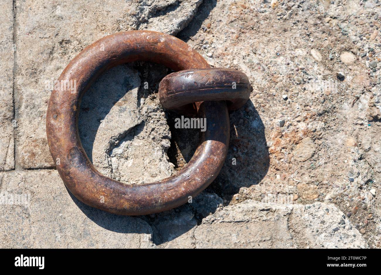 Rusty old mooring loop on textured stone background. Top view Stock ...