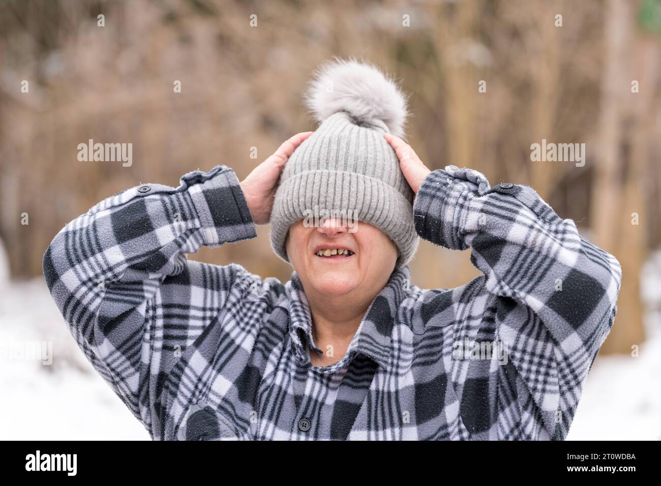 29 January 2023: Woman puts cap over her head and face in winter ...