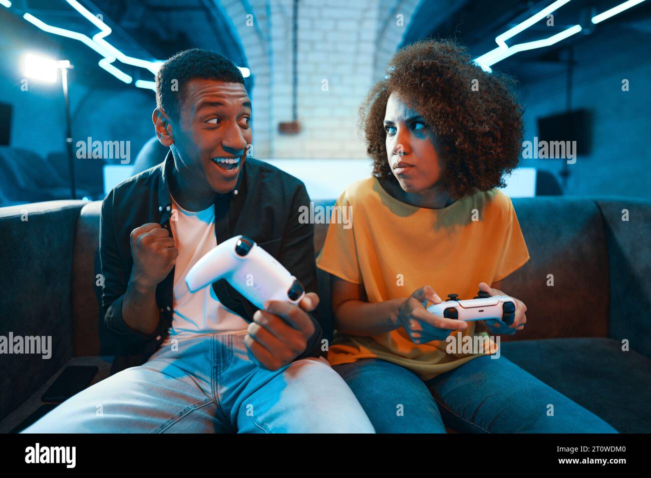 A couple in love is playing a console Stock Photo - Alamy