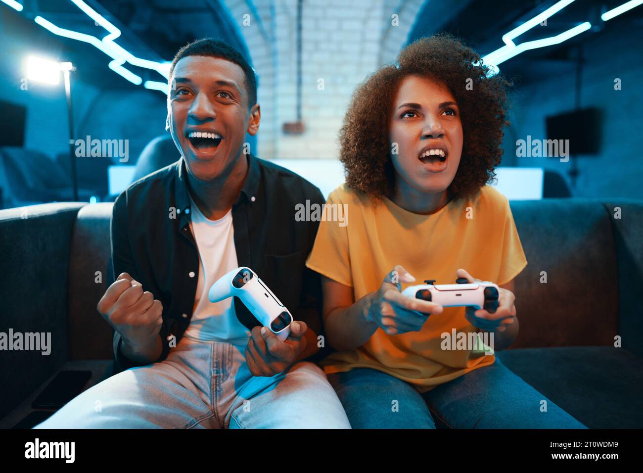 A couple in love is playing a console Stock Photo - Alamy