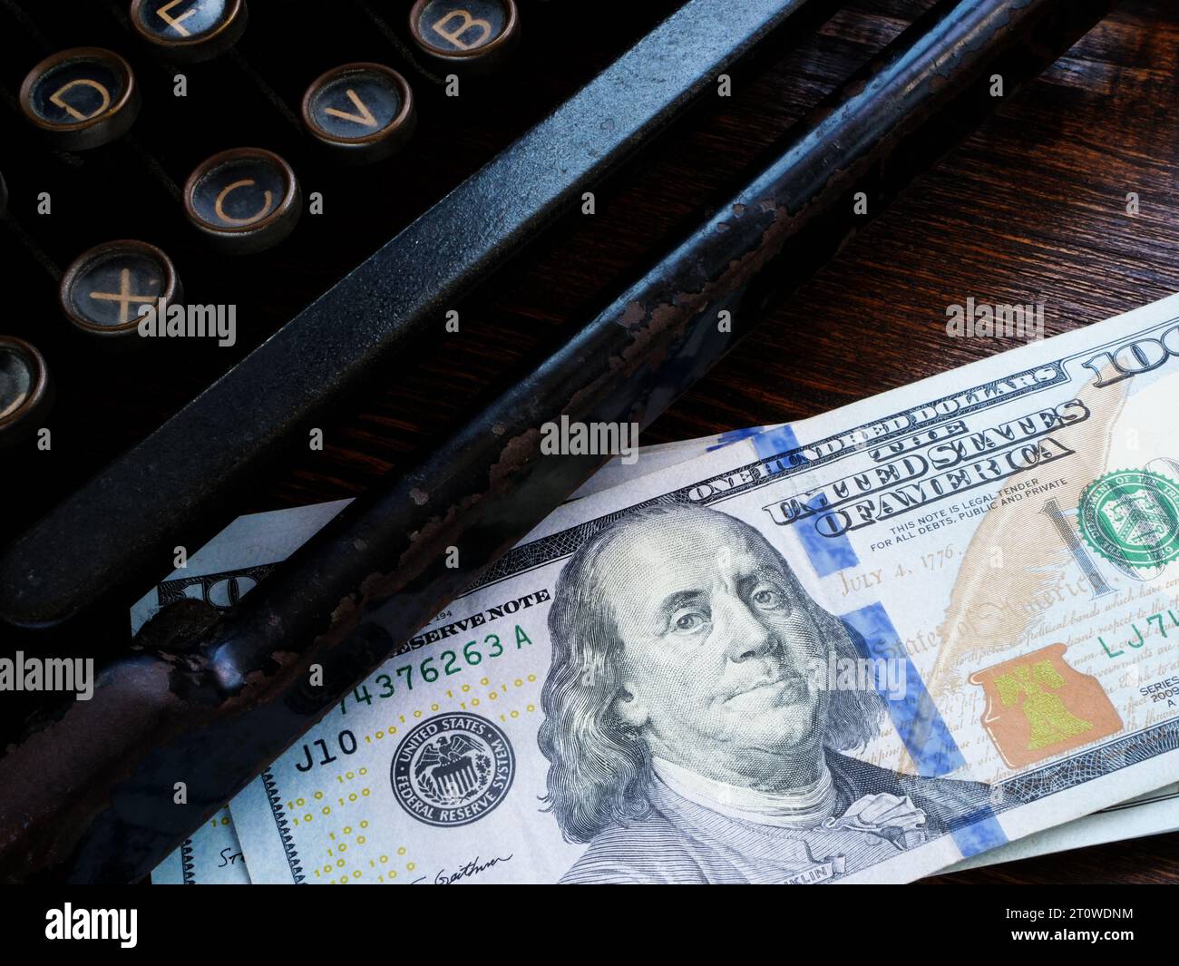 Old typewriter and money as a symbol of monetization and royalties for ...