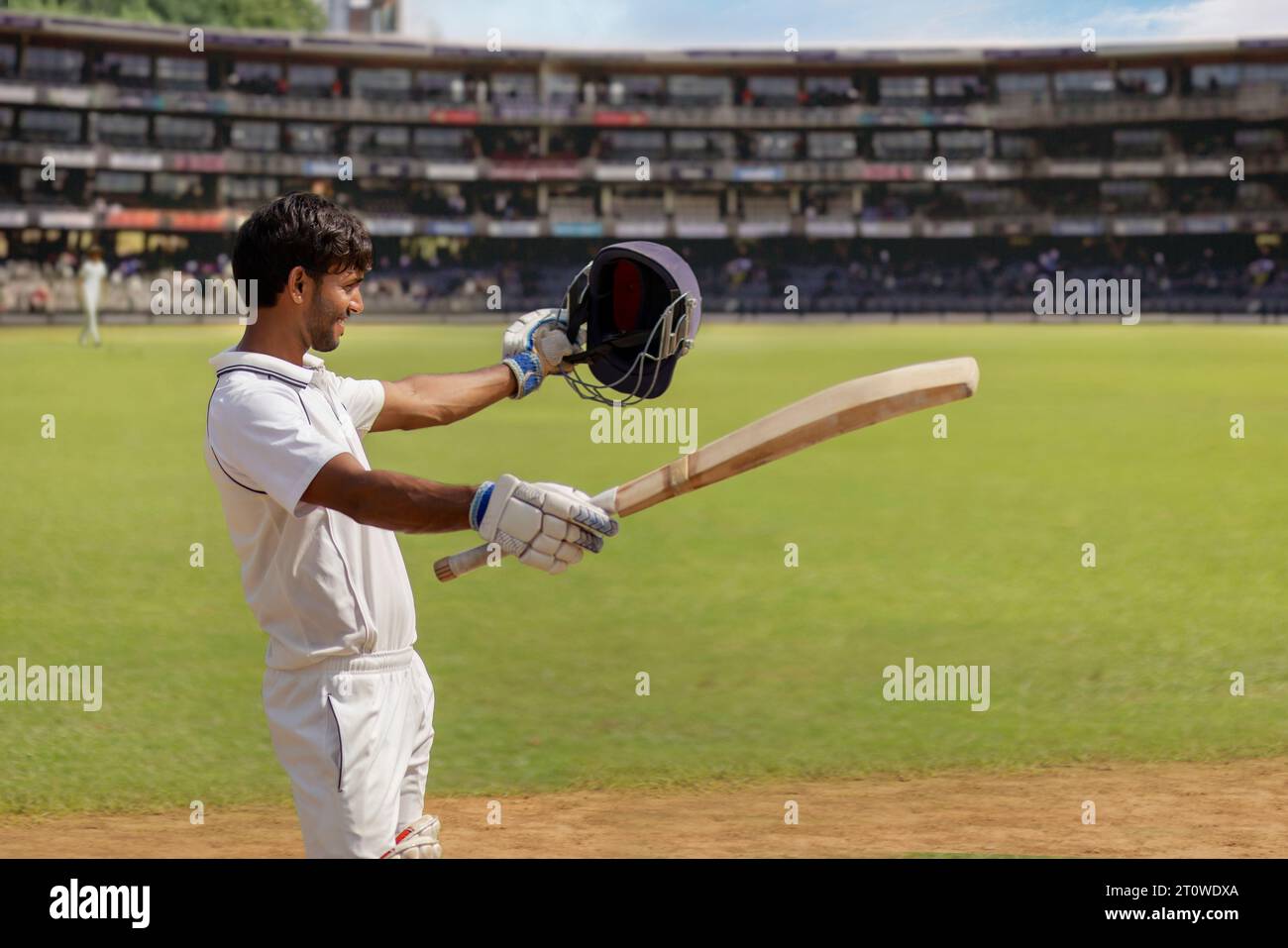 A batsman raising his bat towards the pavillion/crowd as he ...