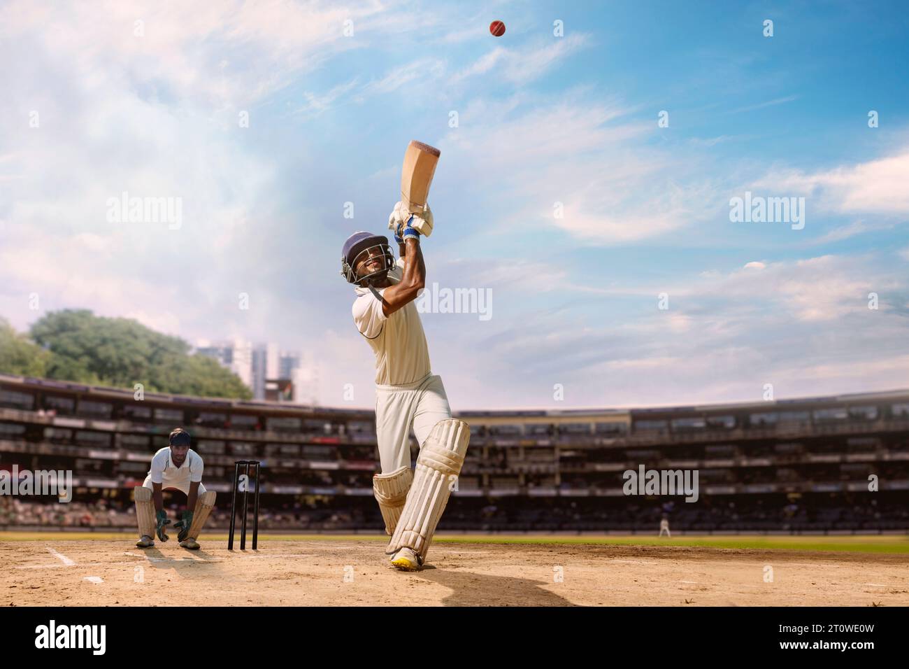 low angle shot of a Cricketer batsman hitting a lofted shot during a ...