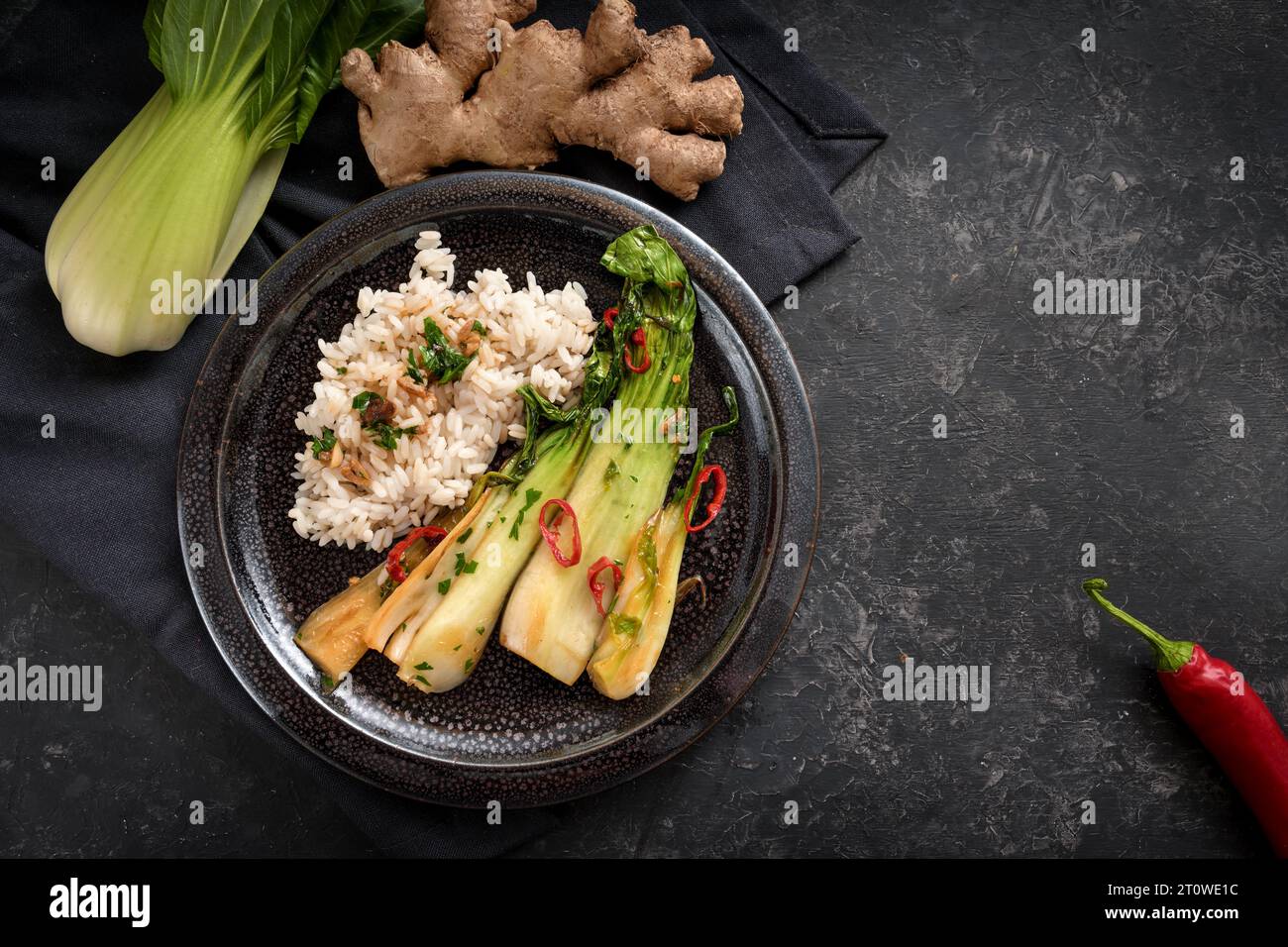 Asian meal from rice and pak choi (Chinese cabbage), fried with garlic ...
