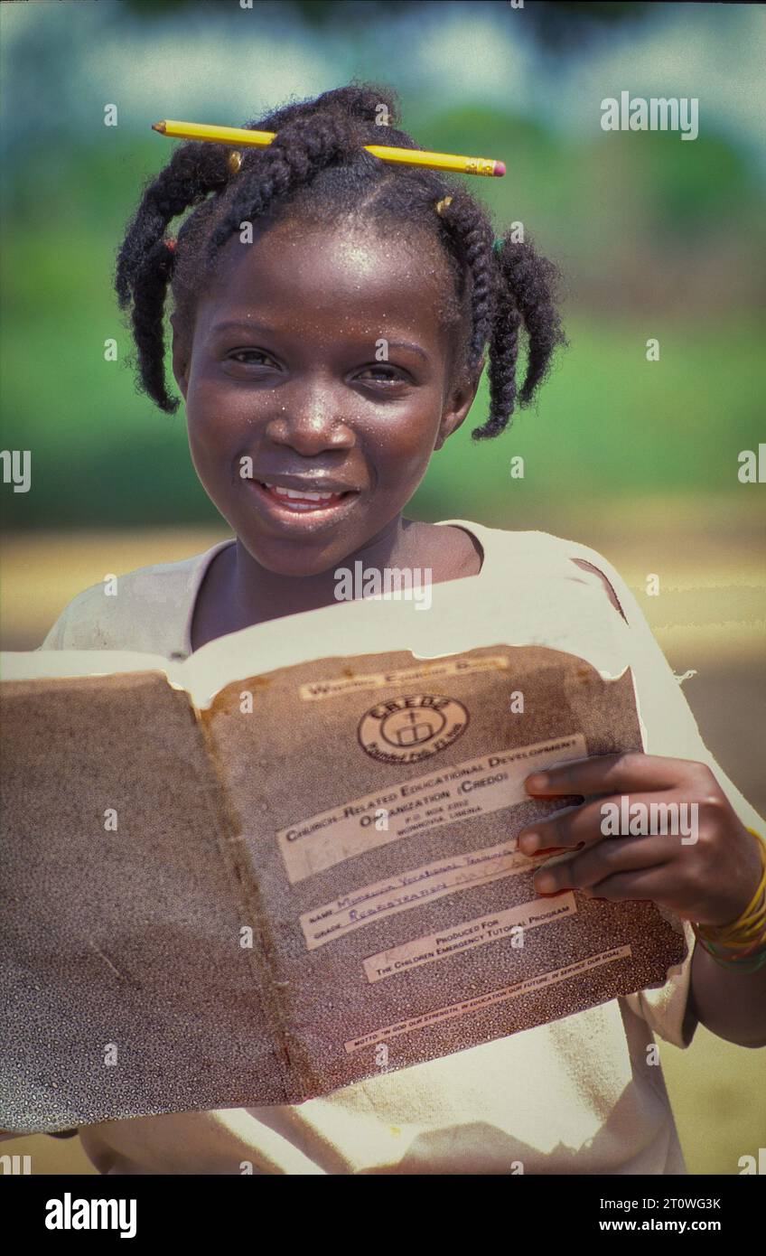 Liberia, Monrovia - portrait of a schoolgirl holding a textbook Stock ...