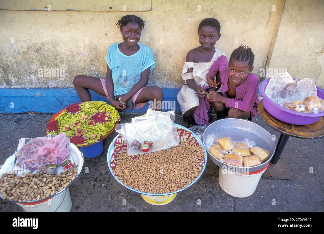 Liberia, Monrovia; Child labour. Girls selling food on the street Stock ...