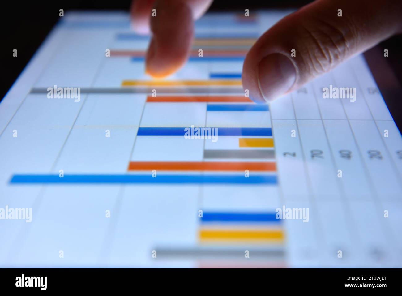 Close up of businessman touching tablet screen with stock market charts ...