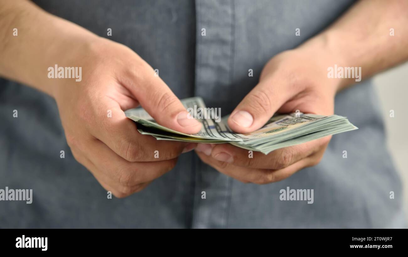 Hundred dollar bills in hands hi-res stock photography and images - Alamy