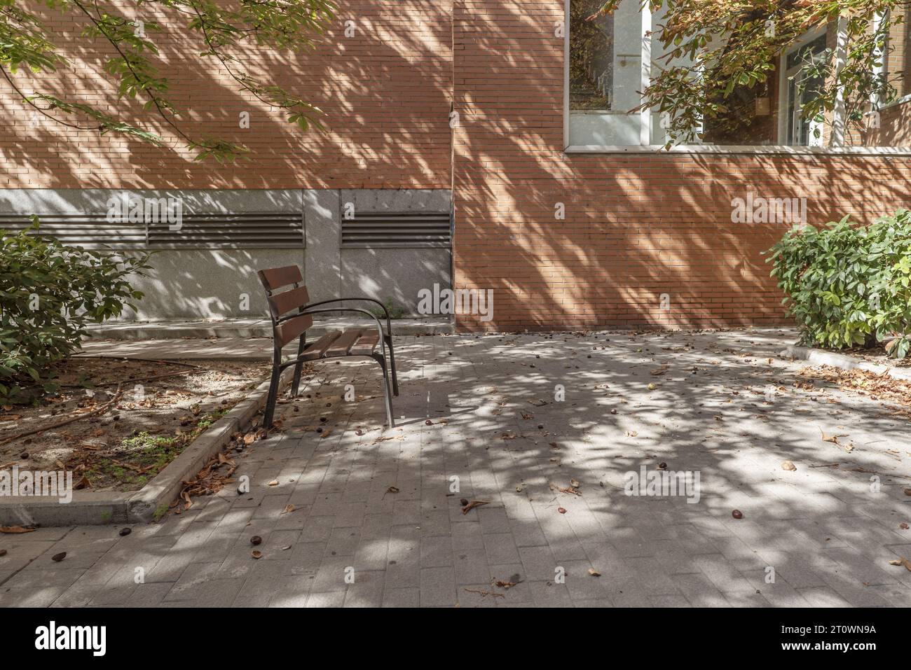 A small solitary garden bench on an urban street Stock Photo - Alamy