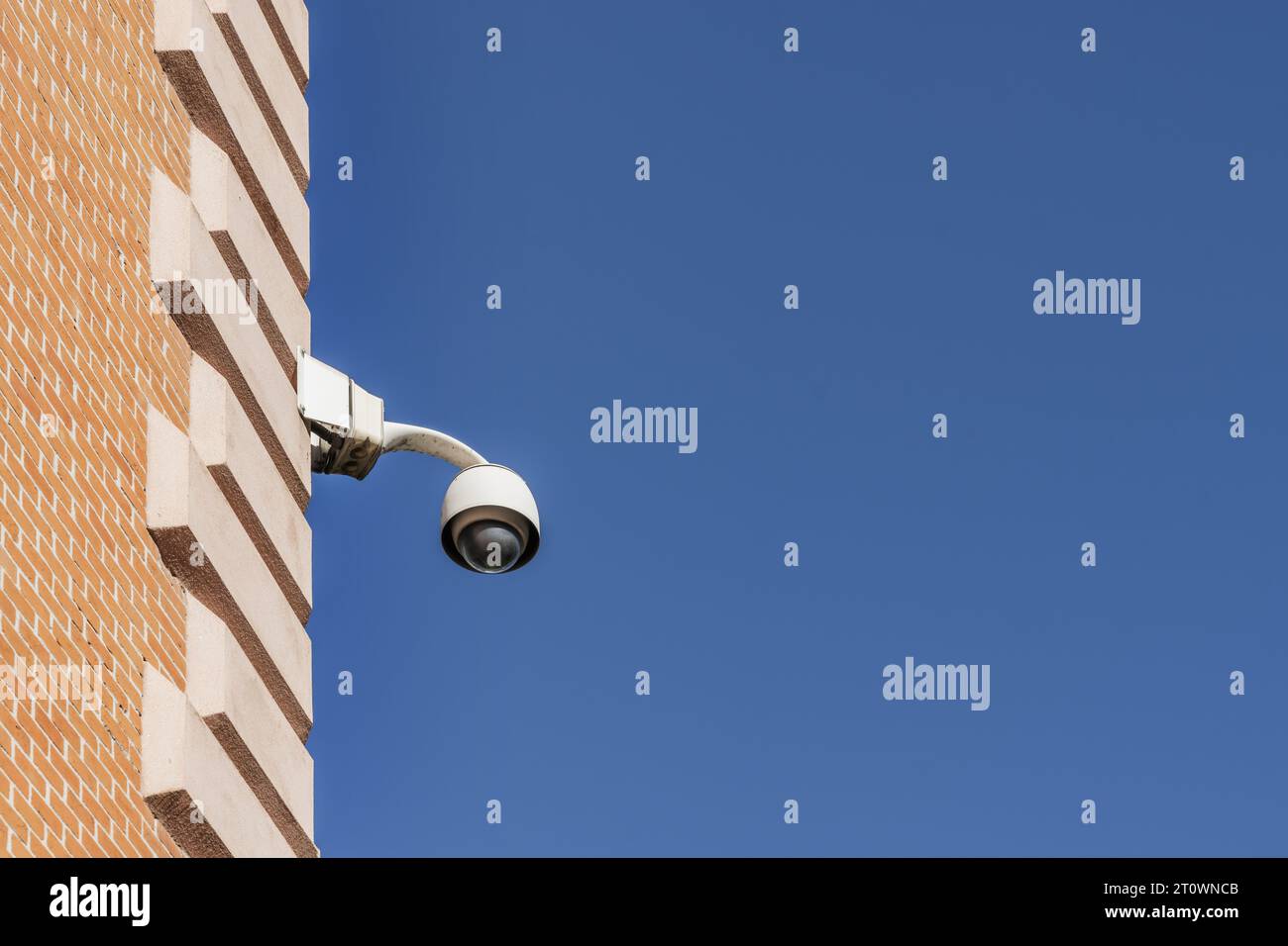 A surveillance camera placed in a corner of a building on a day Stock ...