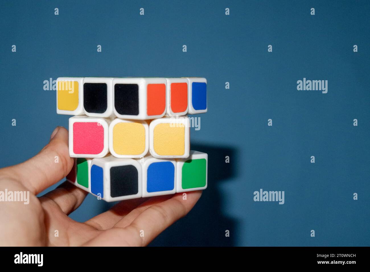 Photo of a person holding a rubik on a light blue background Stock ...