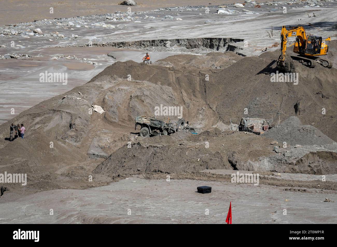 Indian army personnel dig sand along the Teesta river as they continue ...