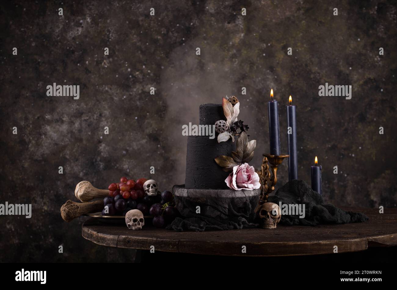 Halloween still life with skull, bones and cake Stock Photo - Alamy