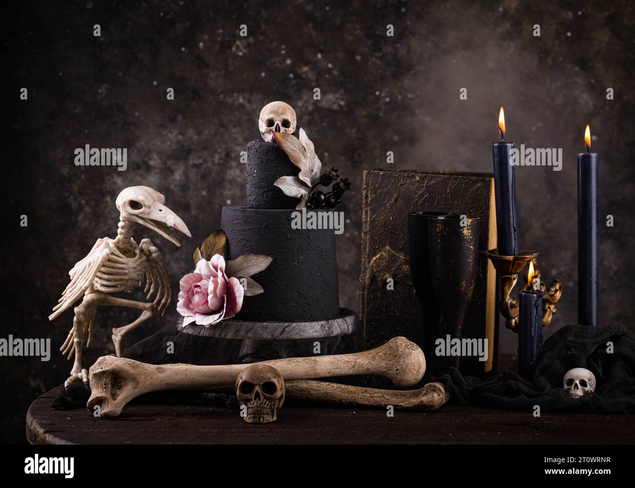 Halloween still life with skull, bones and cake Stock Photo - Alamy