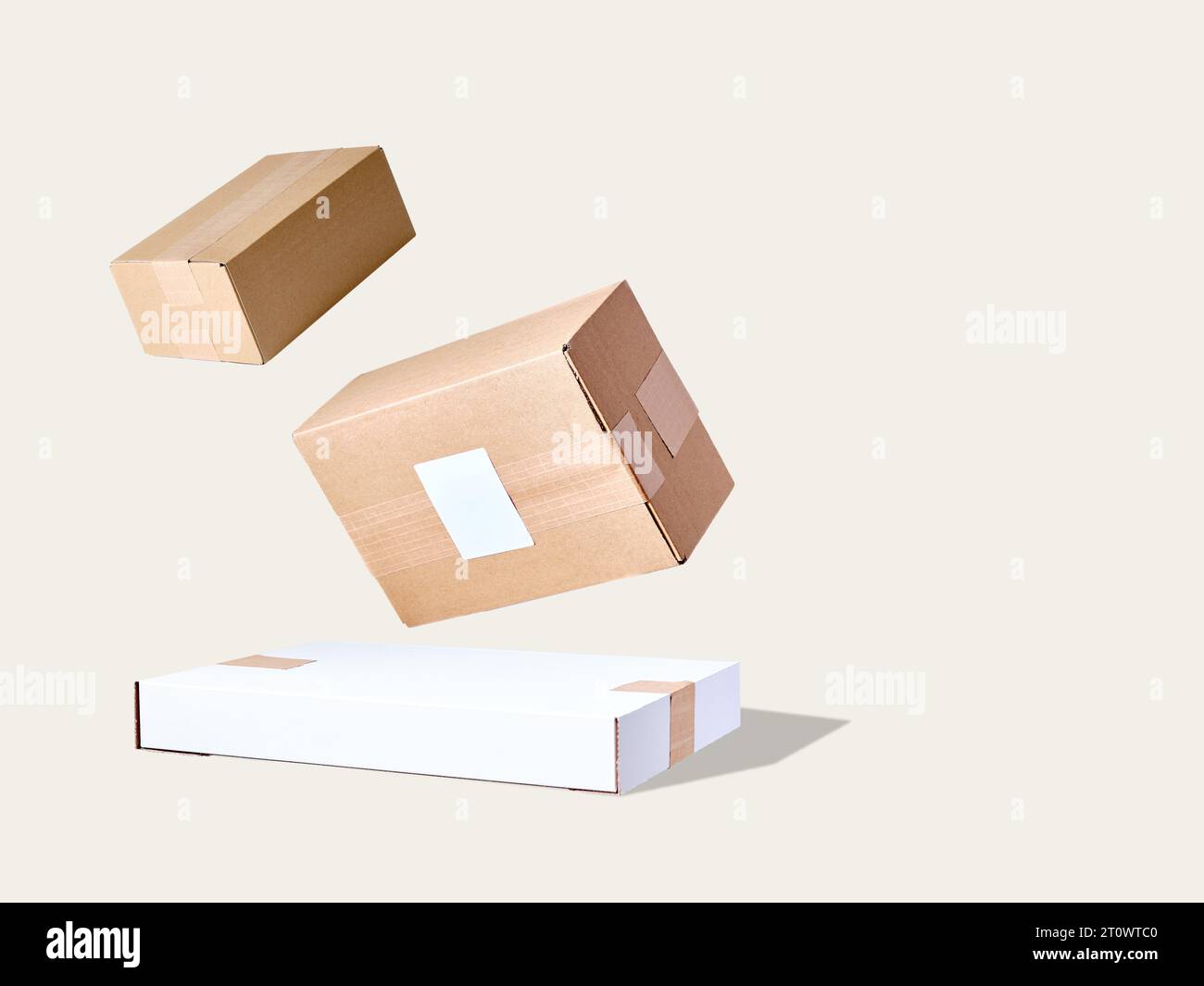 Stack of cardboard parcels floating against beige background Stock ...