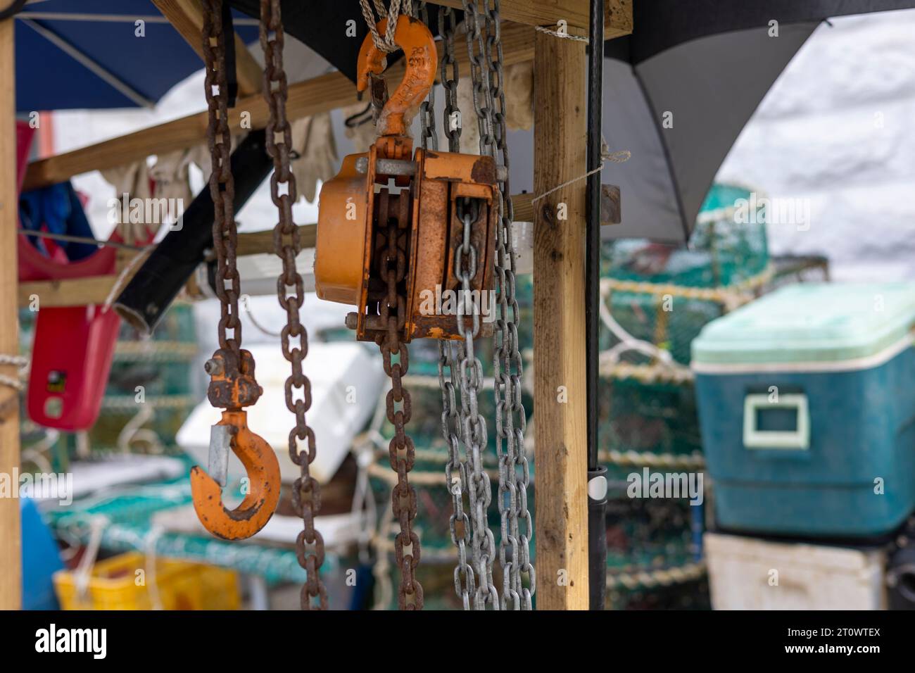 A seashore port town piled with fishery-related tools, chains, pulleys ...