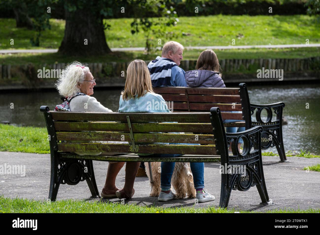 People sitting on benches and chatting to each other in Trenance ...