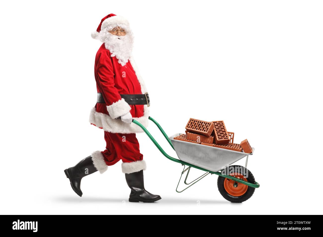 Full length shot of santa claus pushing a wheelbarrow with bricks ...