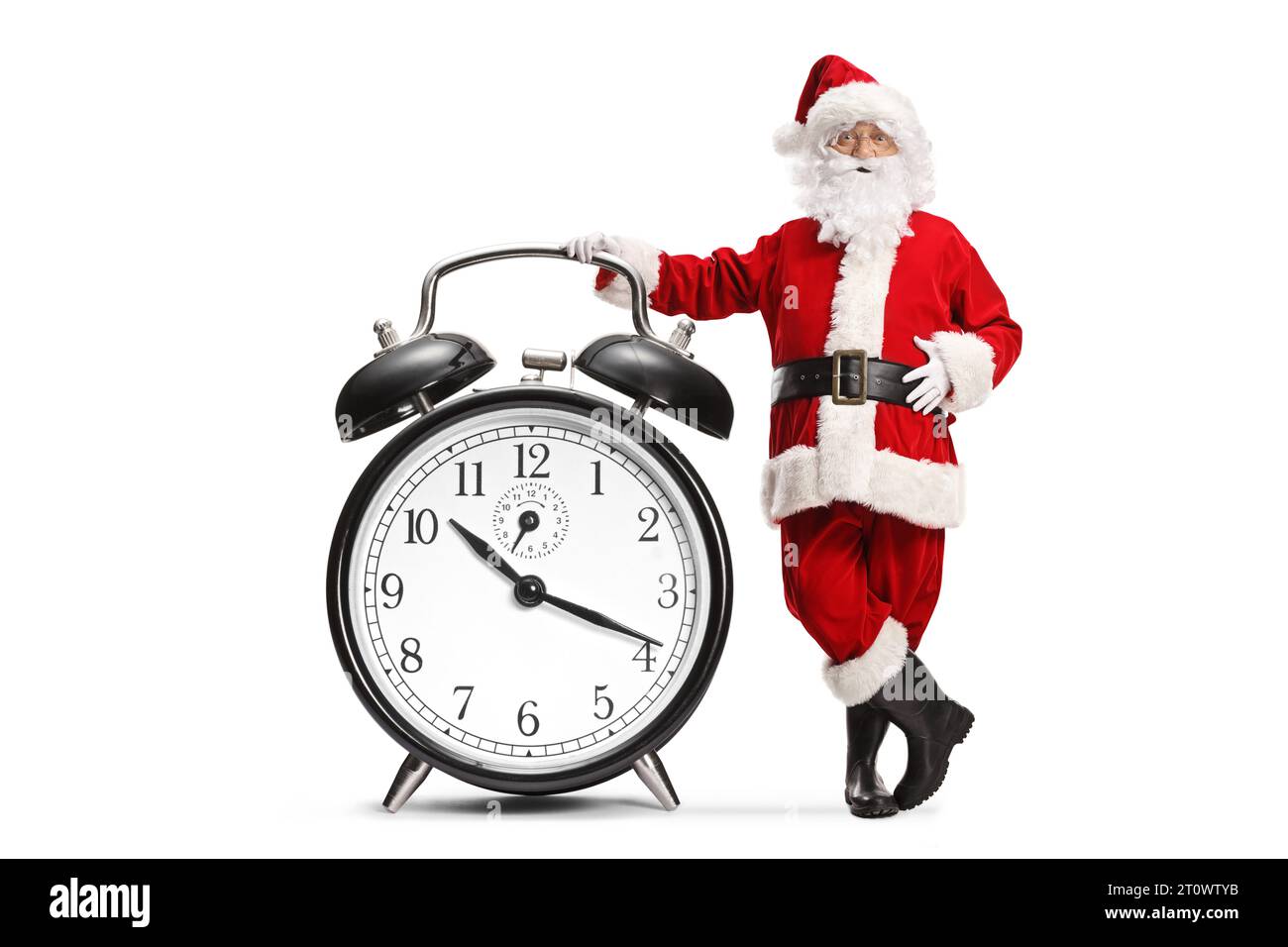 Santa claus leaning on a big alarm clock isolated on white background ...