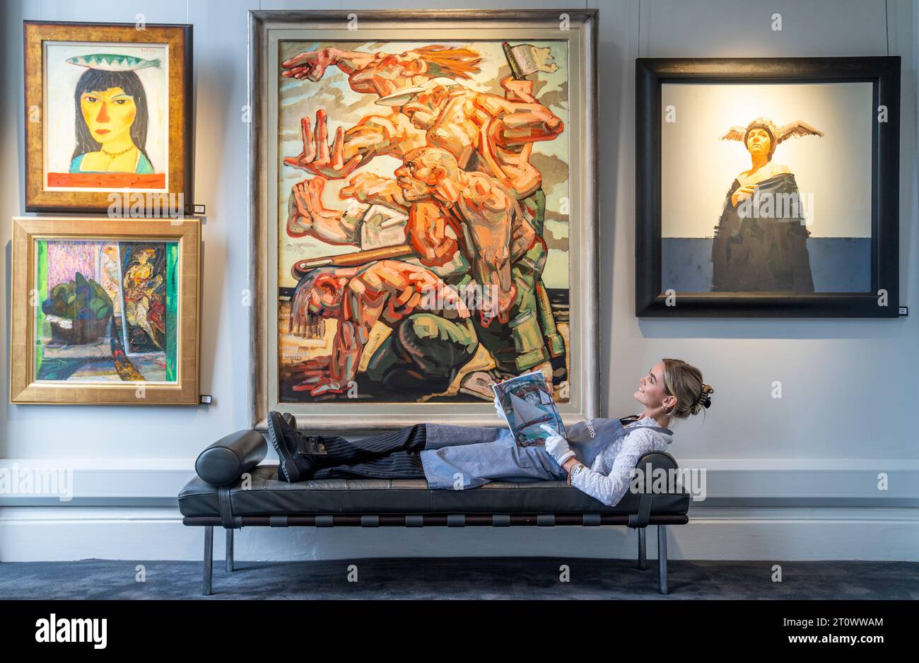 Bonham’s Gemma Radburn-Todd reads the sale catalogue underneath an oil ...