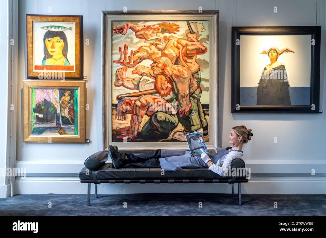 Bonham’s Gemma Radburn-Todd reads the sale catalogue underneath an oil ...